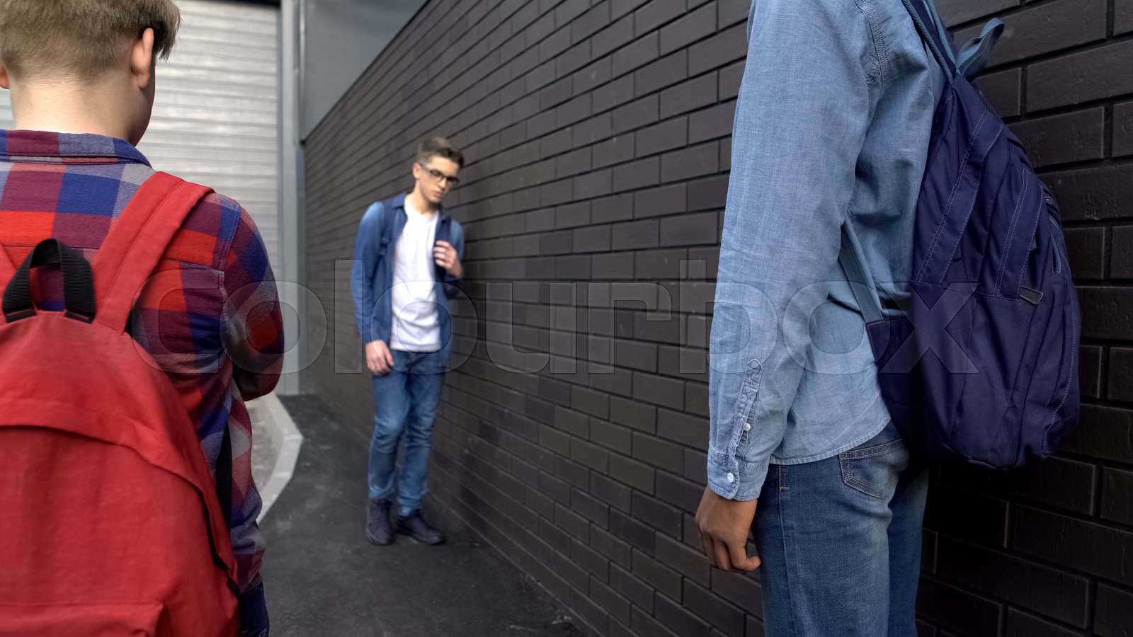 Hooligans threatening weak boy in school backyard, bullying, provoking ...