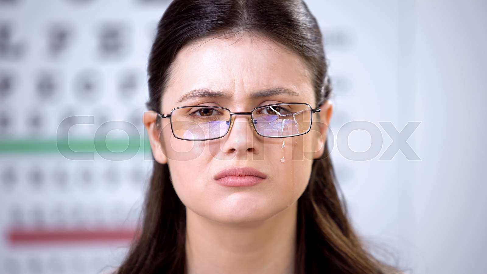 Sad lady in broken glasses looking to camera and crying suffering poor ...