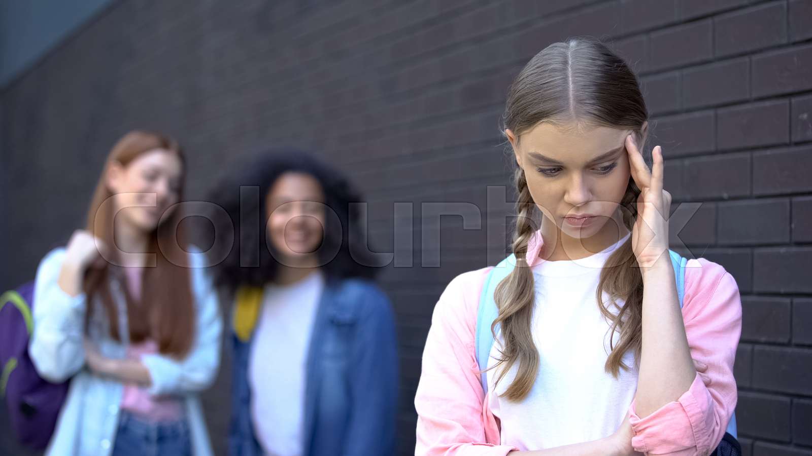 Humiliated pupil suffering classmates bullying on backyard ...