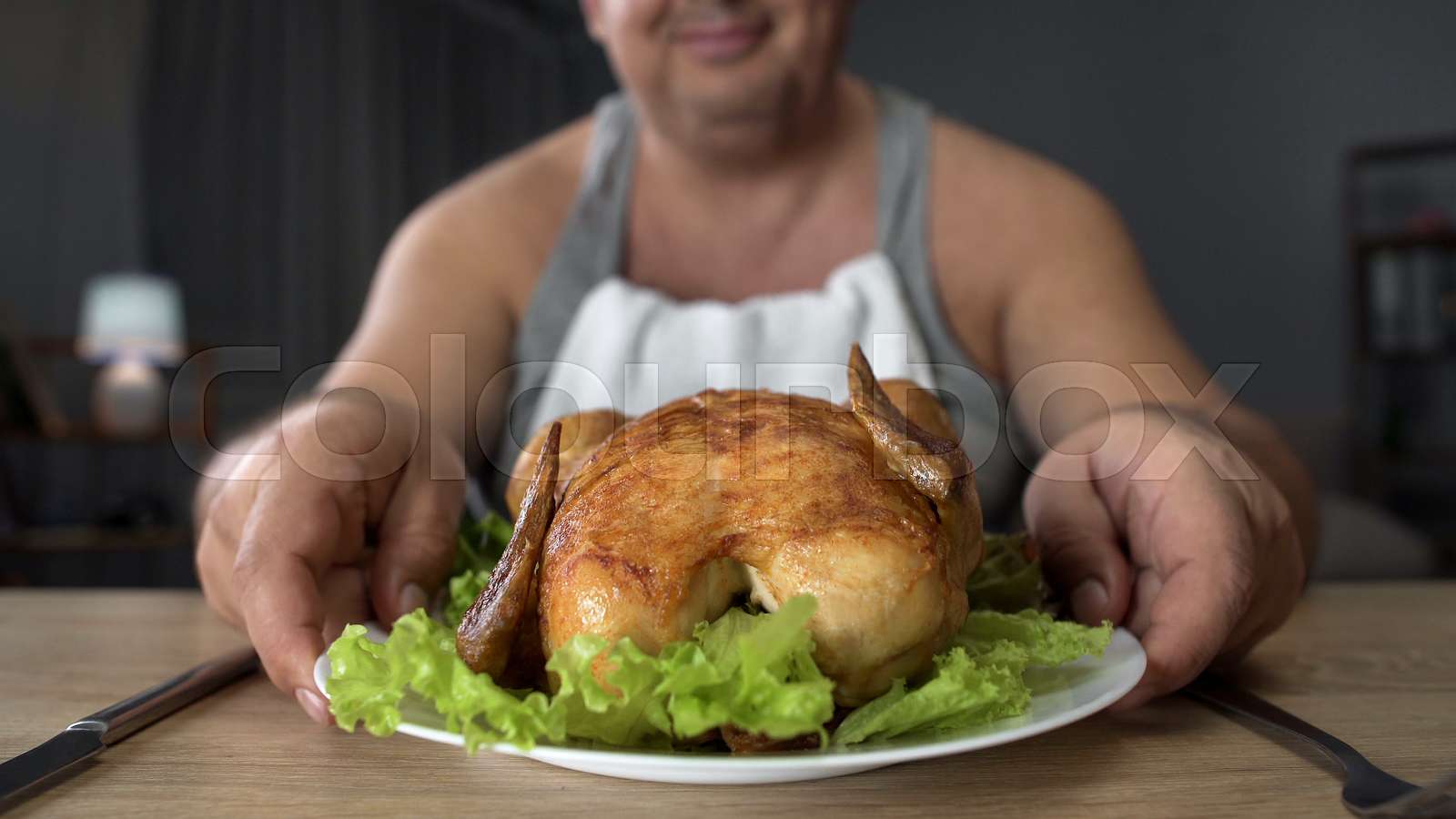 Smiling obese male looking at fatty grilled chicken, overeating and ...