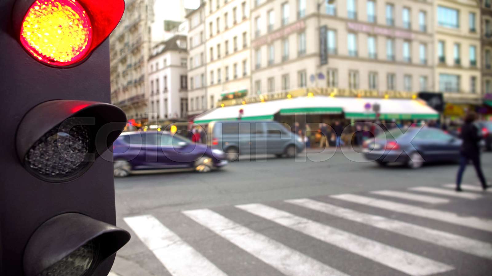 Red light for street traffic, pedestrian crossing road, rush hour in ...
