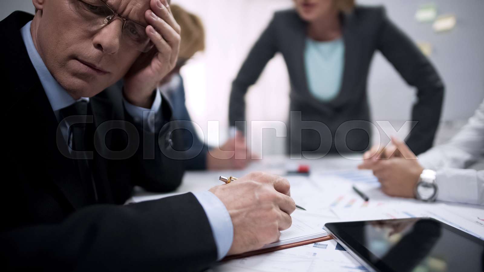 Tired office worker feeling scared, suffering at meeting with terror ...