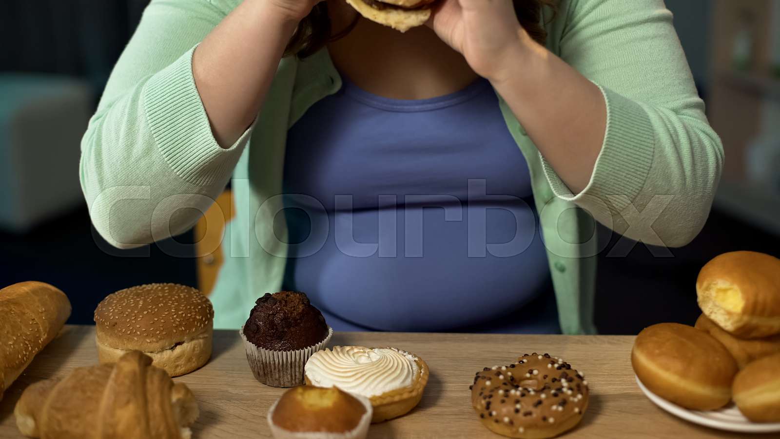Overweight woman consuming too much bakery, eating stress with ...