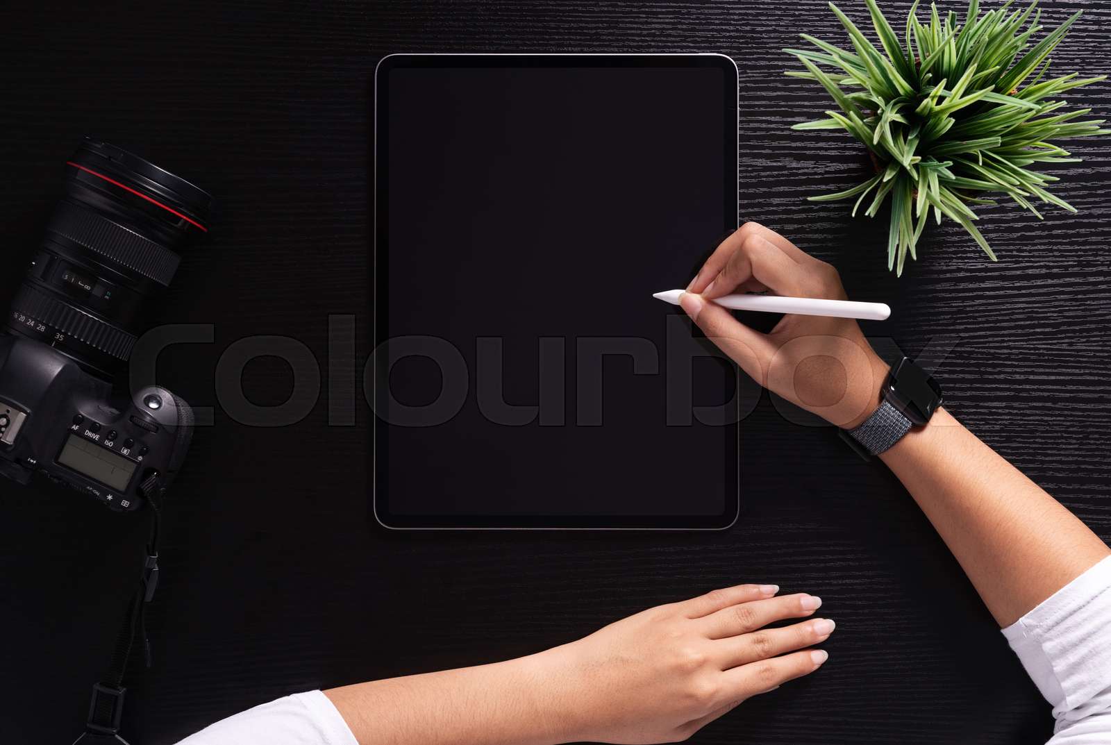 designer using stylus pen on top view | Stock image | Colourbox