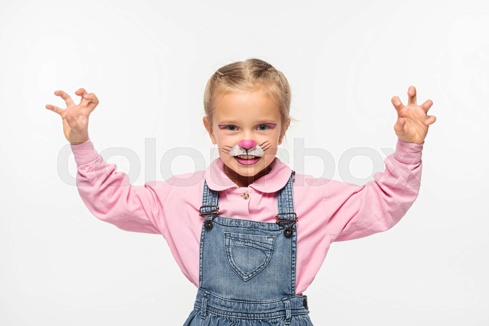 cute child with cat muzzle painting on face showing frightening gesture ...