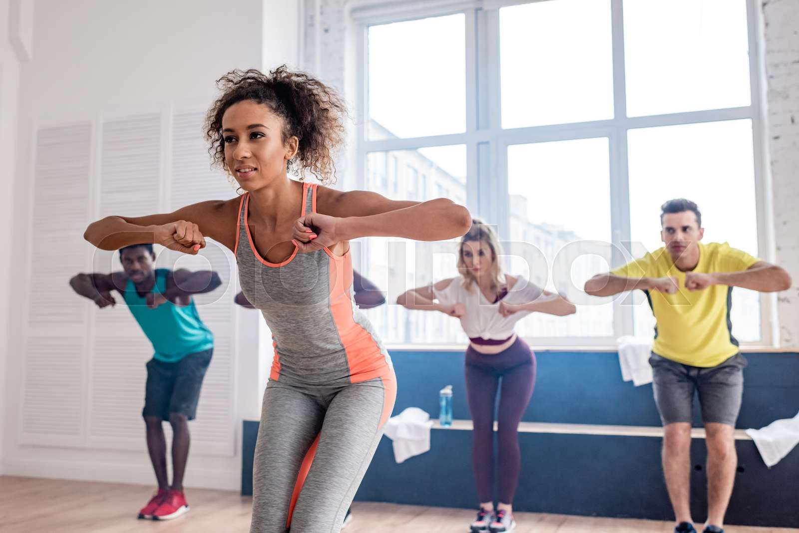 Selective focus of african american trainer leaning with multiethnic ...