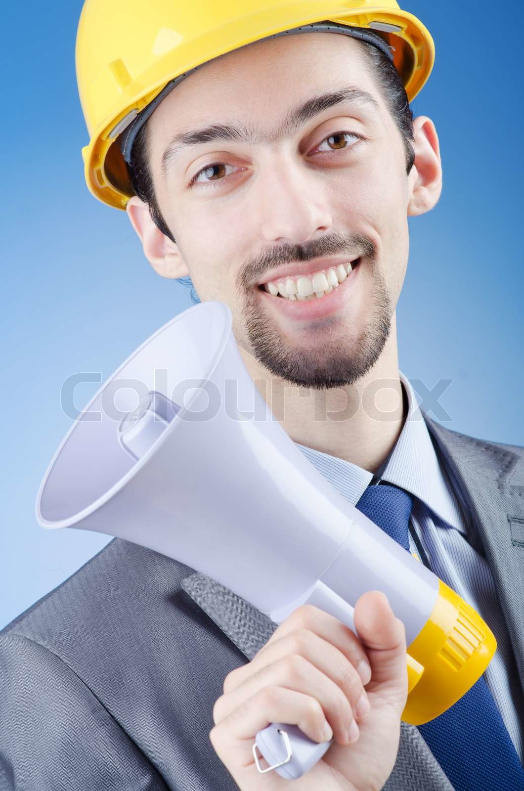 Construction worker shouting via loudspeaker | Stock image | Colourbox