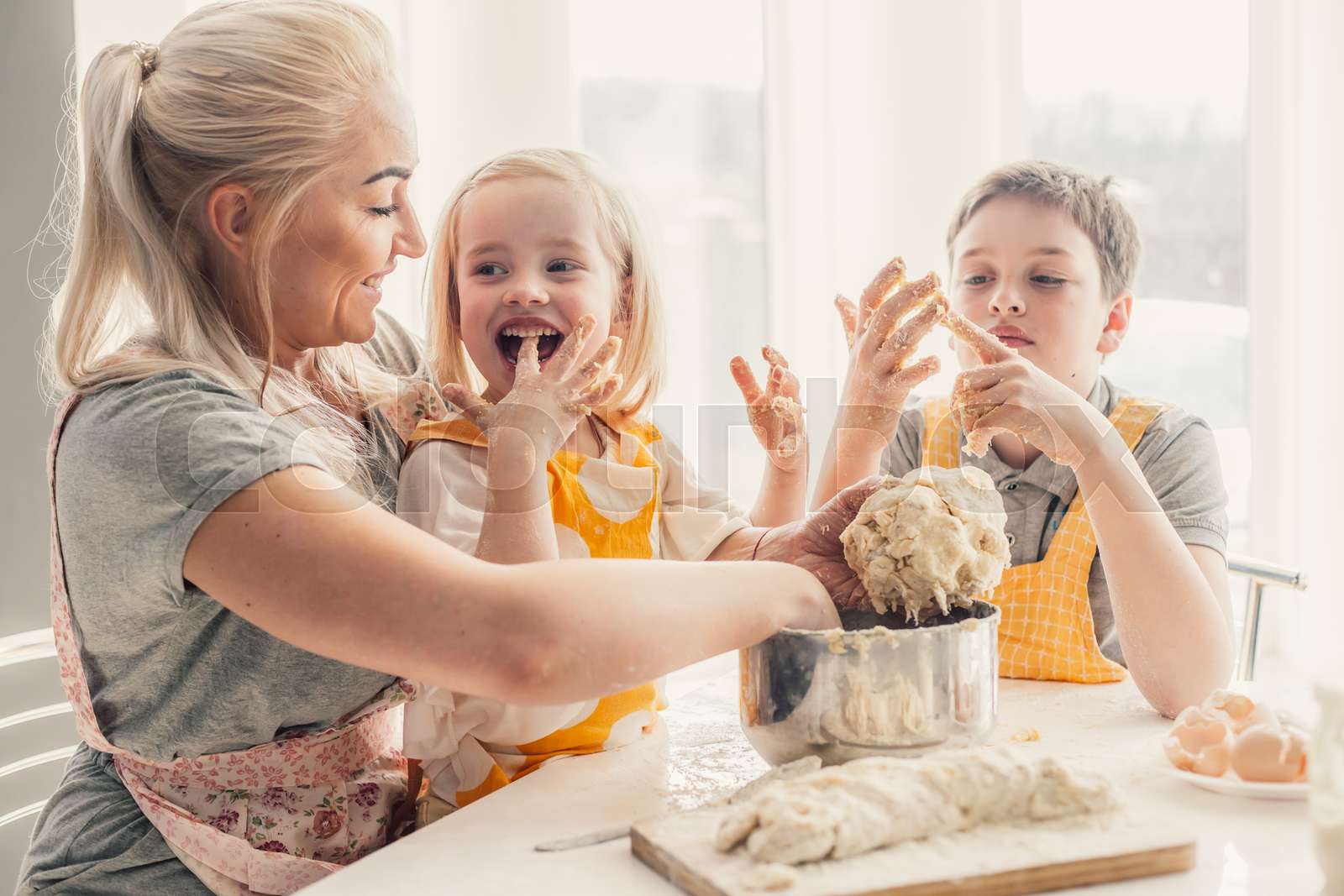 Mom cooking with kids on the kitchen | Stock image | Colourbox