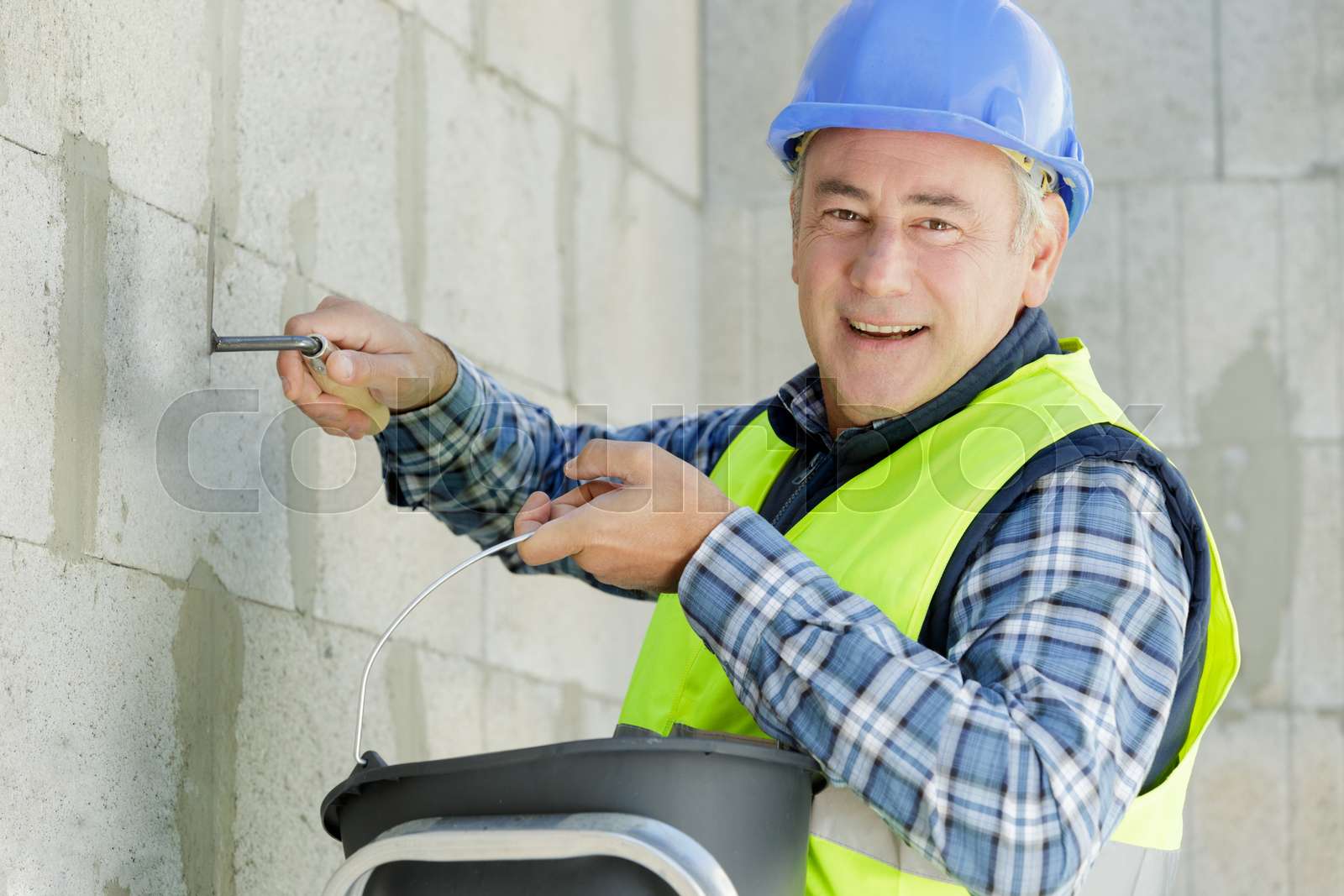 mature mason at work using trowel | Stock image | Colourbox