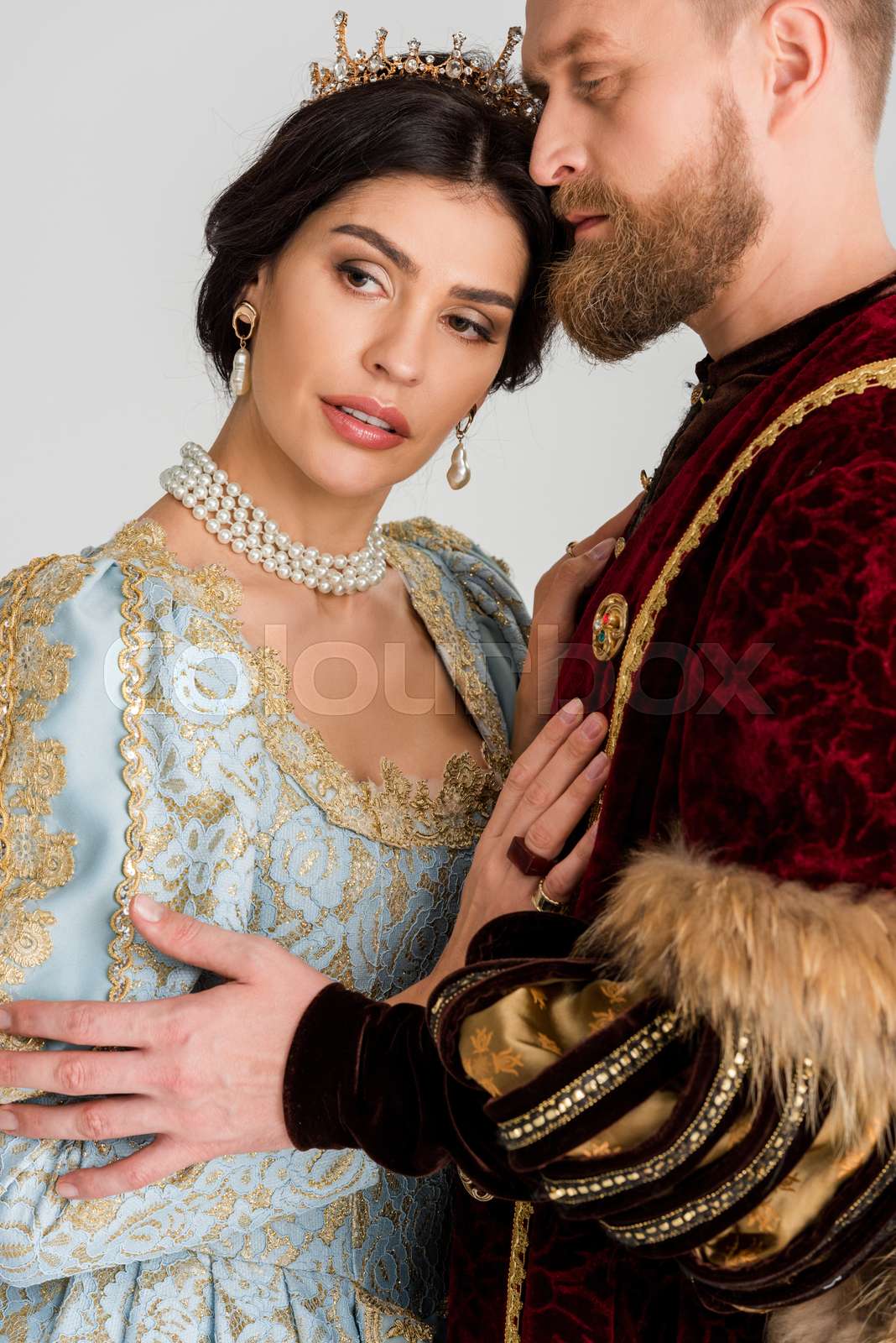 cropped view of king hugging queen with crown isolated on grey | Stock ...