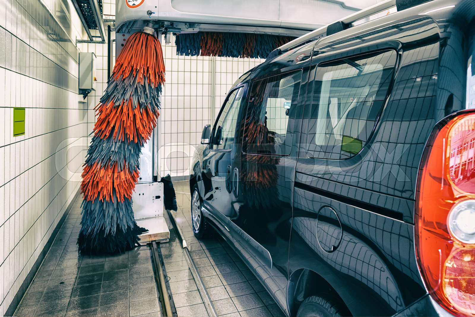 Black modern delivery minivan car cleaning with robot automatic tunnel ...