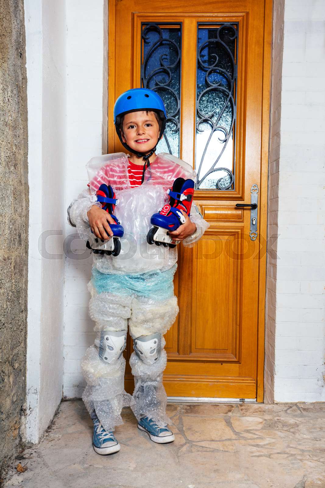 Boy with rollers in overprotective bubble wrap | Stock image | Colourbox