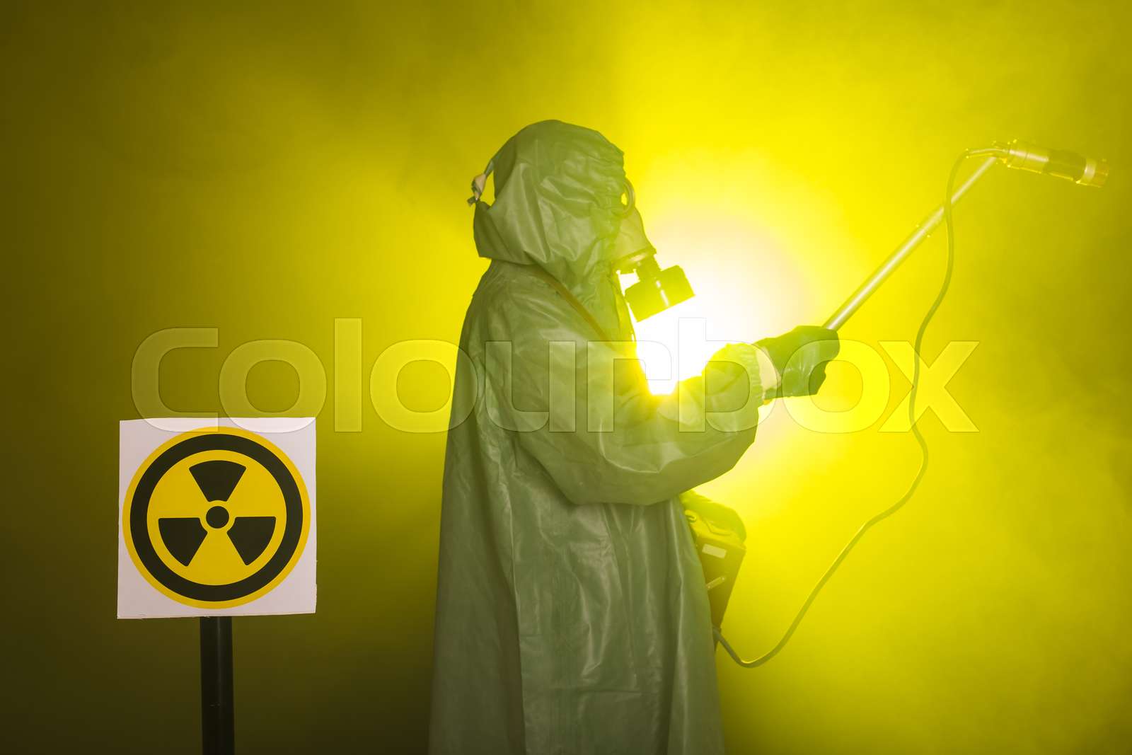 Radiation and danger concept - Man in the gas mask and chemical suit ...