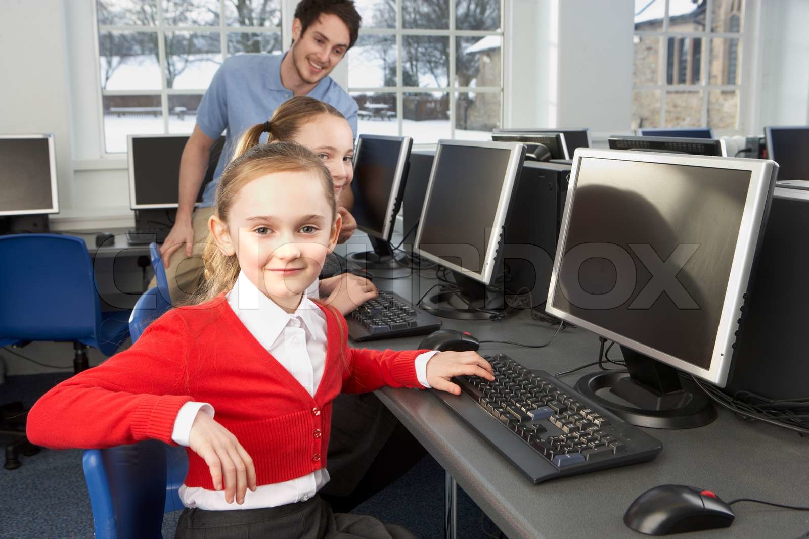 Girls using computers in school class | Stock image | Colourbox