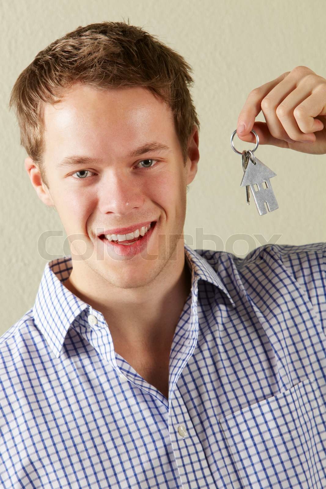 Studio Shot Of Young Man Holding Keys To First Home | Stock image ...