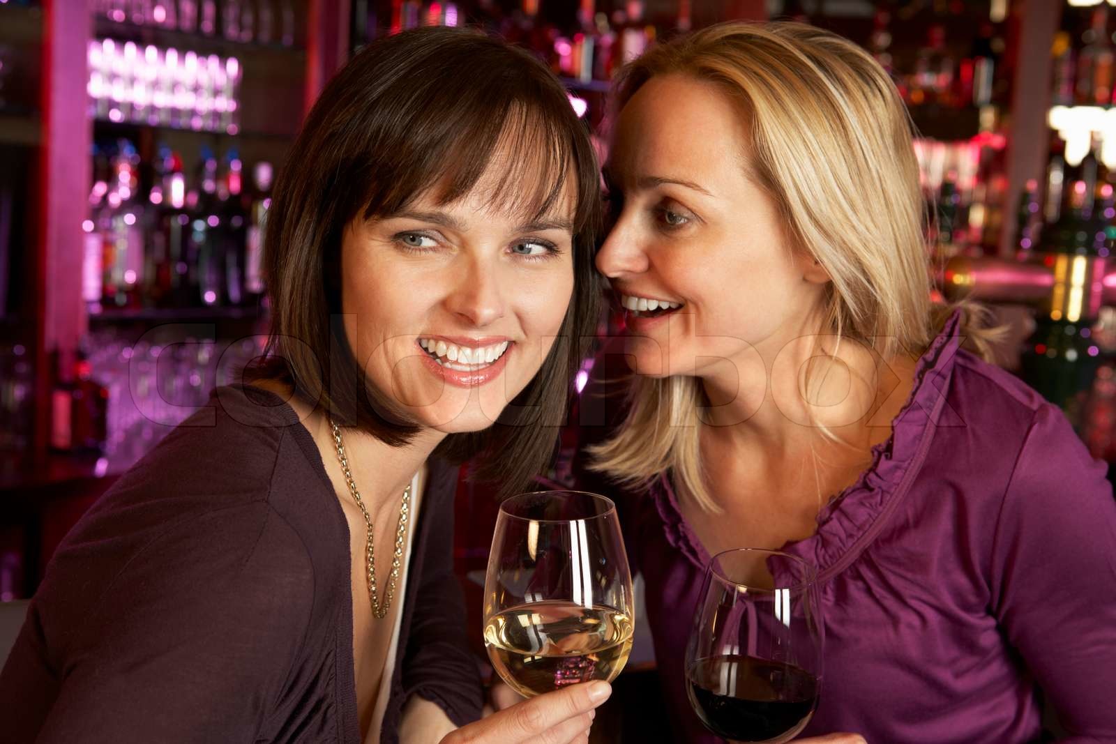 Two Women Enjoying Drink Together In Bar | Stock image | Colourbox