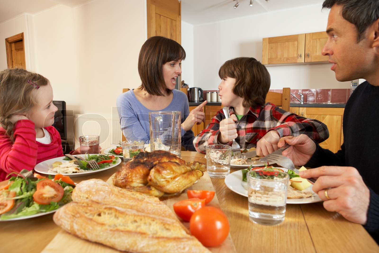 Family Having Argument Whilst Eating Lunch Together In Kitchen | Stock ...