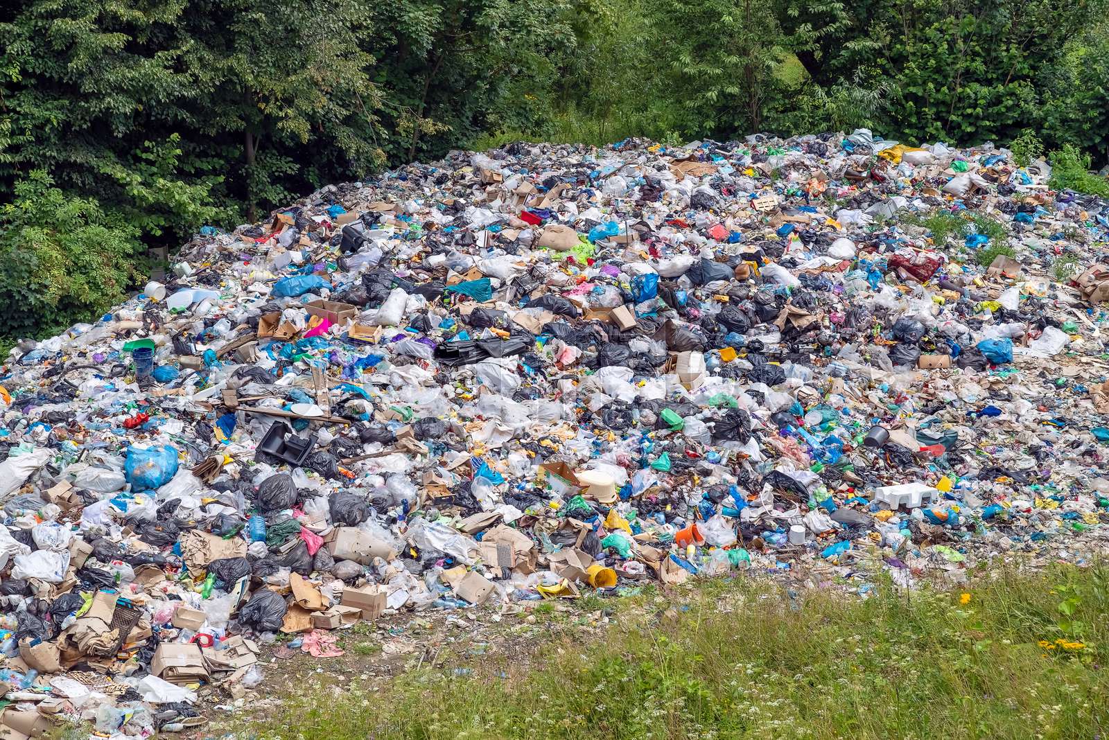 Unauthorized landfill. Pile of domestic garbage. Background ...