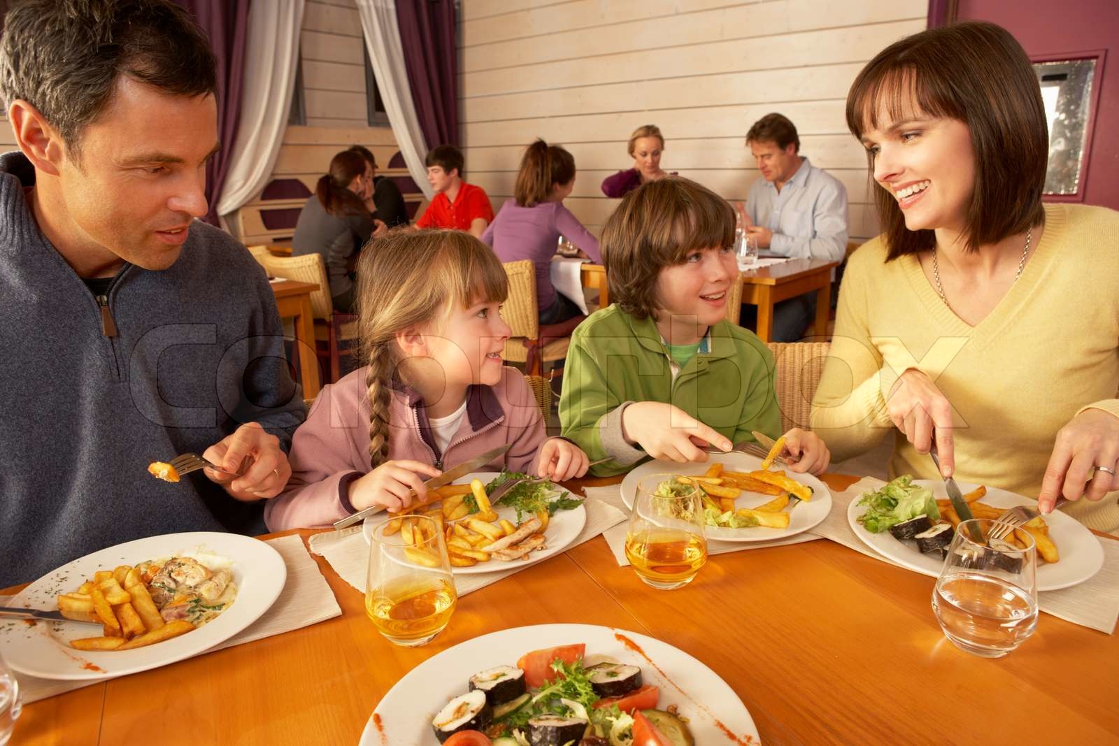 Family Eating Lunch Together In Restaurant | Stock image | Colourbox