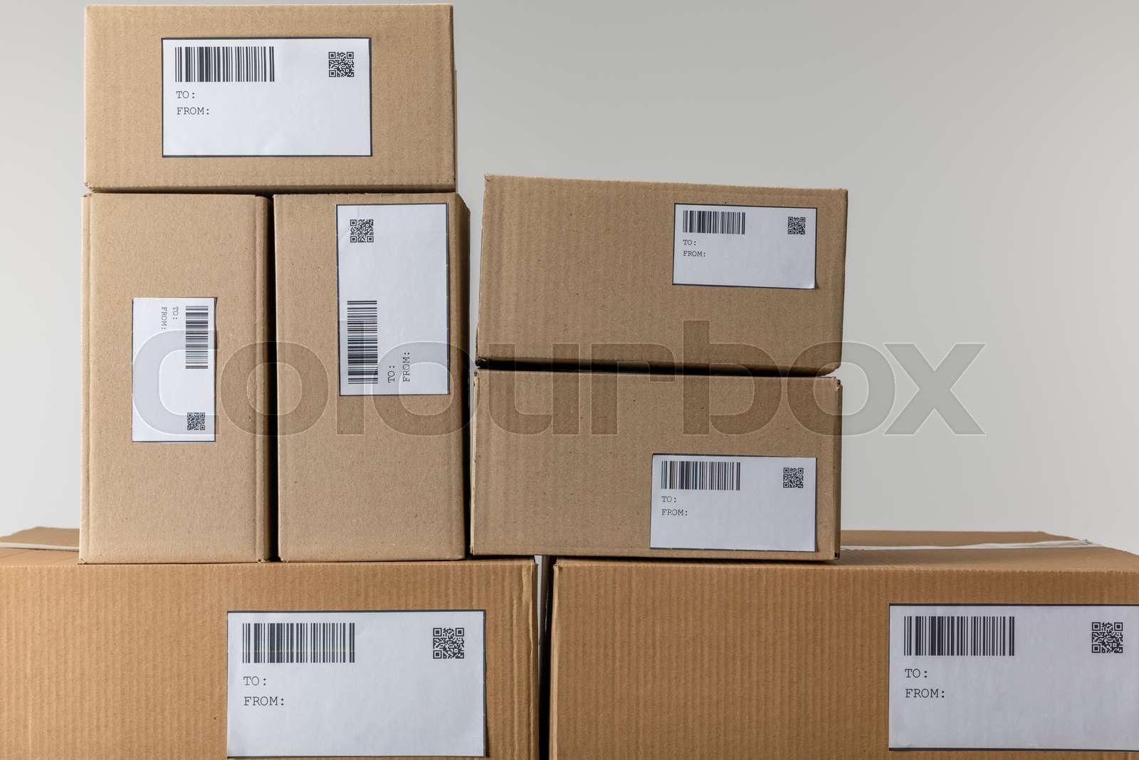 Stacked cardboard boxes with barcodes and qr codes isolated on grey ...