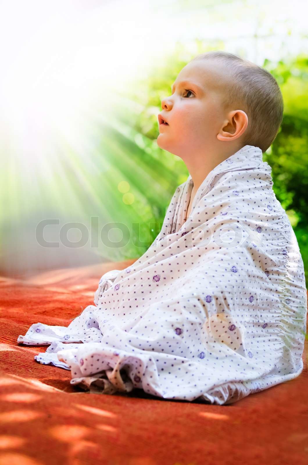 Young child looking in awe at the sun | Stock image | Colourbox