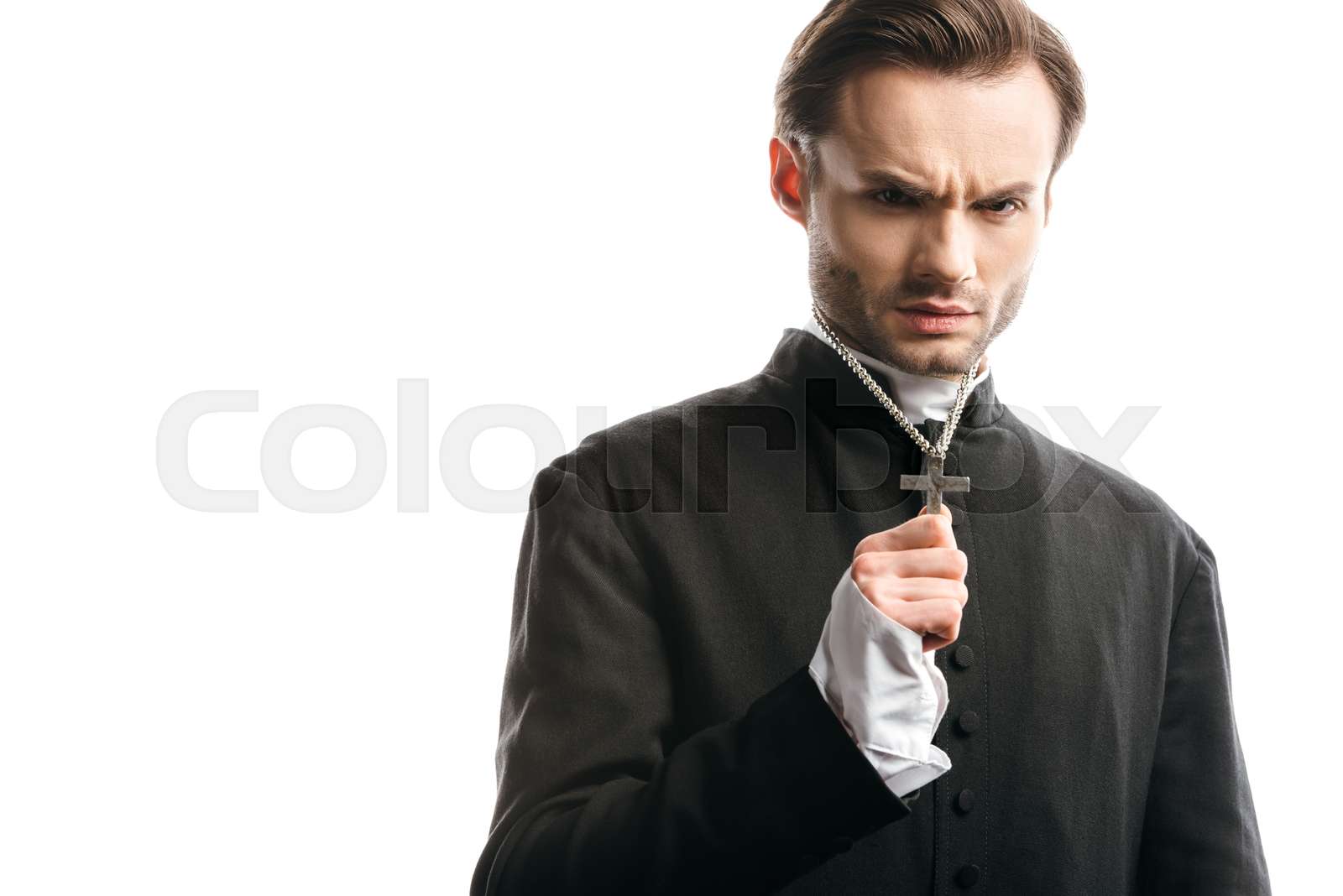 serious, strict catholic priest showing holy cross on his necklace ...