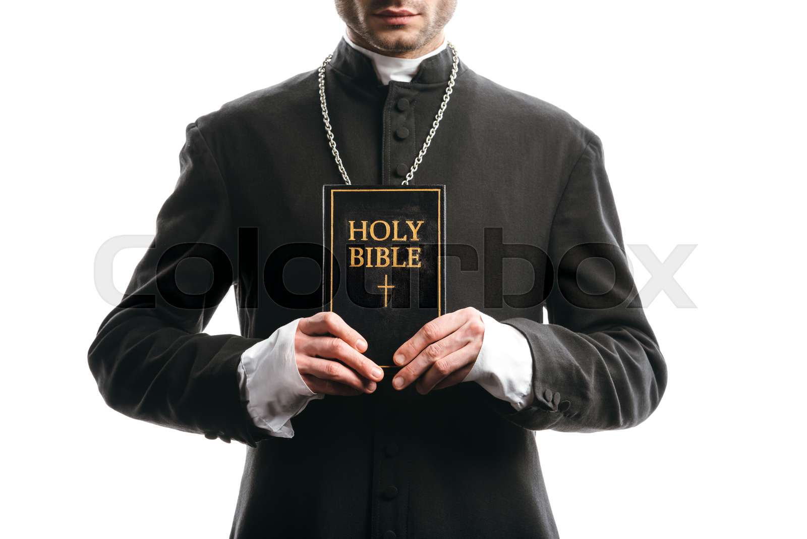cropped view of catholic priest holding holy bible isolated on white ...