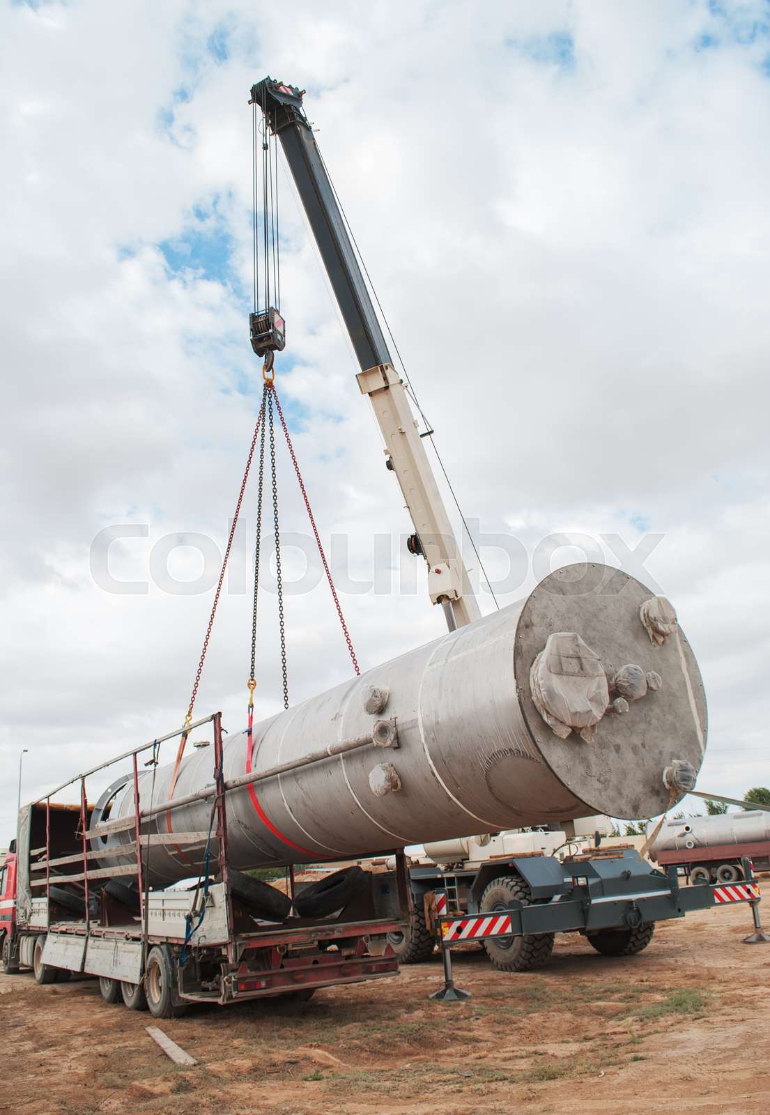 Crane in operation, unloading of industrial equipment. | Stock image ...