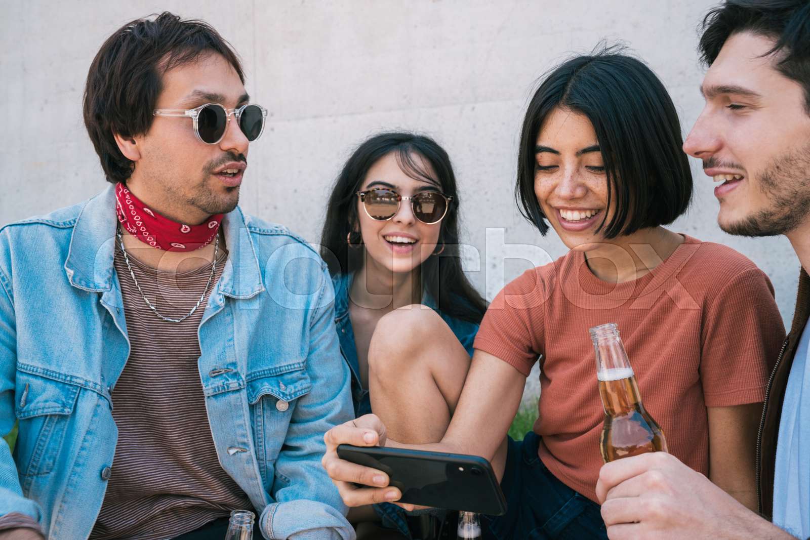 Group of friends watching something in smartphone. | Stock image ...