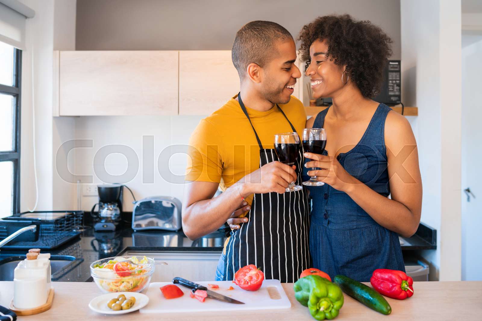 Latin couple cooking together in the kitchen. | Stock image | Colourbox
