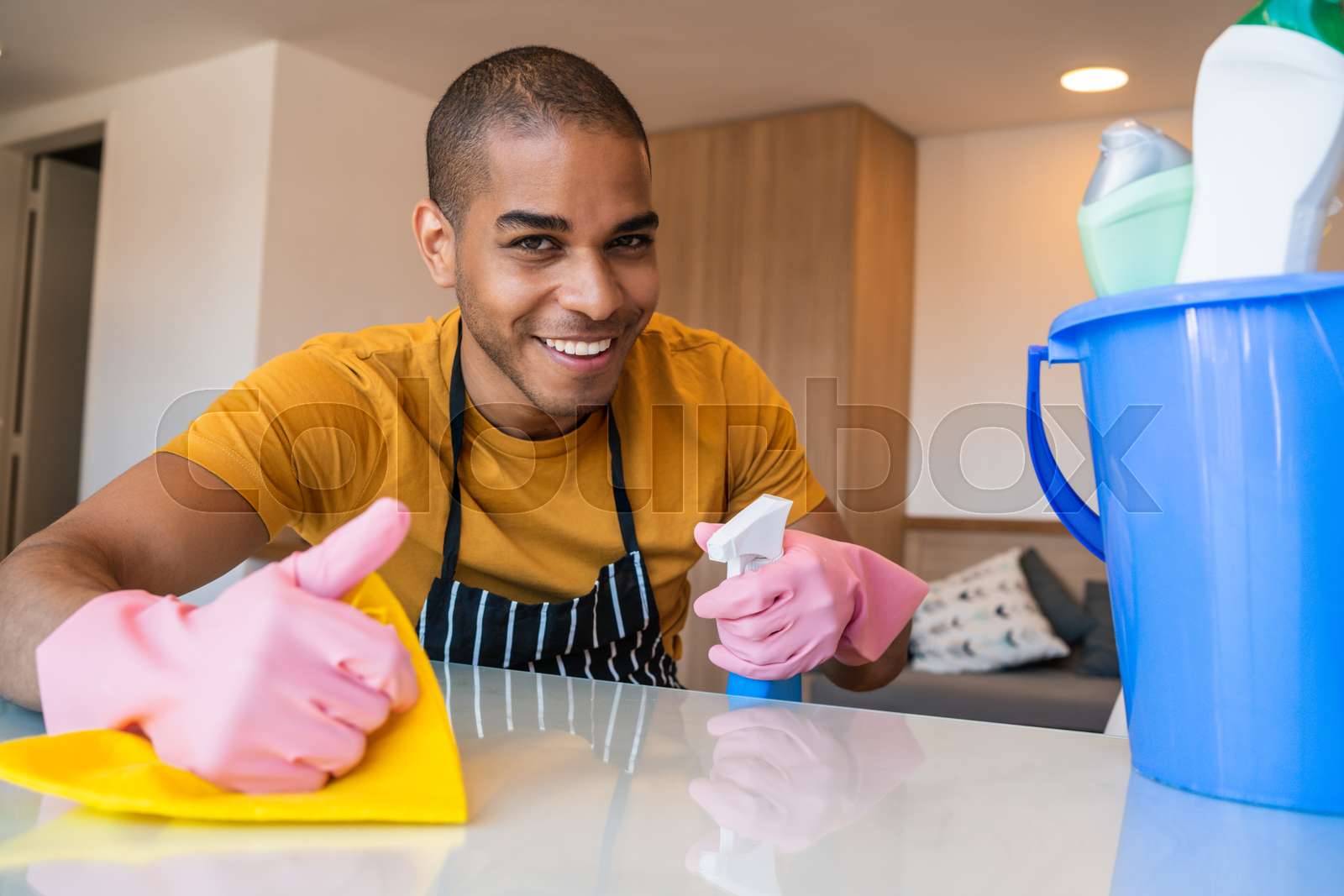 Young latin man cleaning at home. | Stock image | Colourbox
