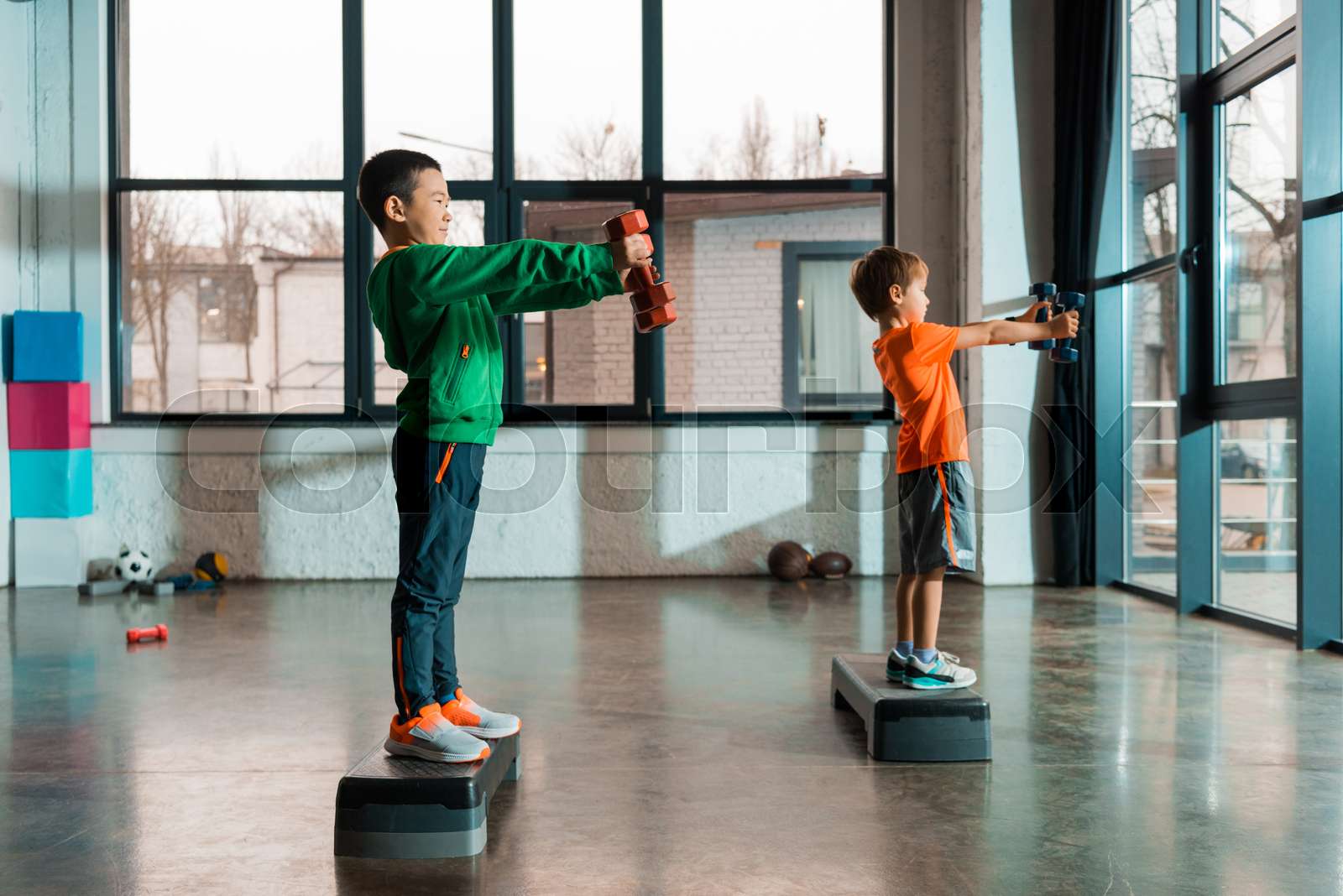 Side view of multicultural kids with outstretched hands holding ...