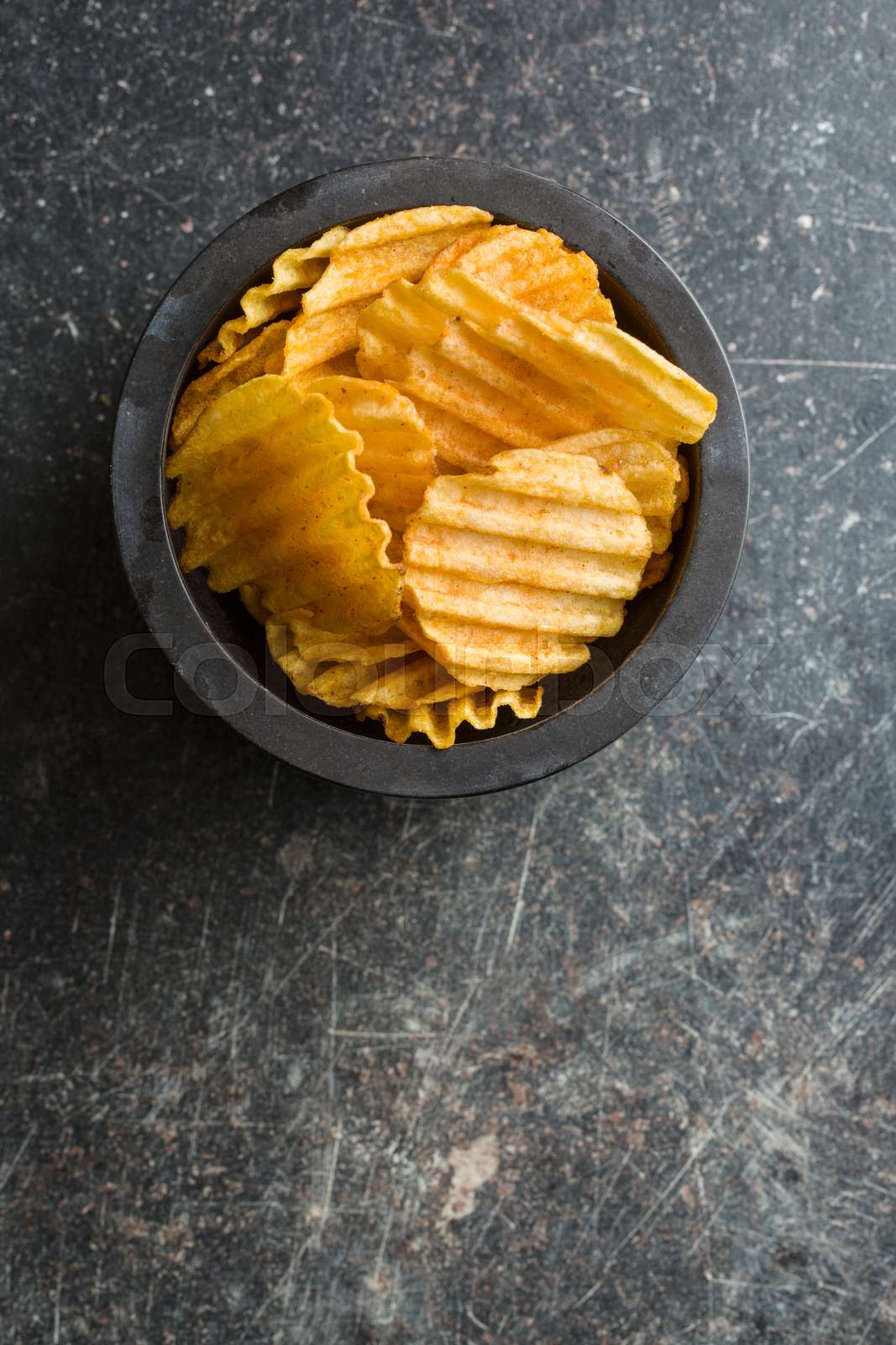 Crinkle cut potato chips. | Stock image | Colourbox
