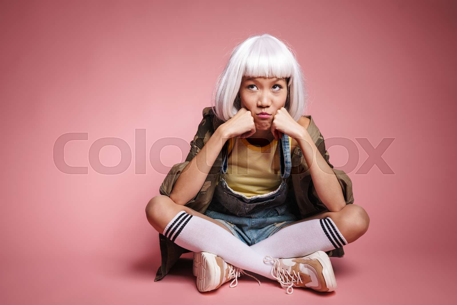 Image of asian girl propping up her head and looking at camera | Stock ...