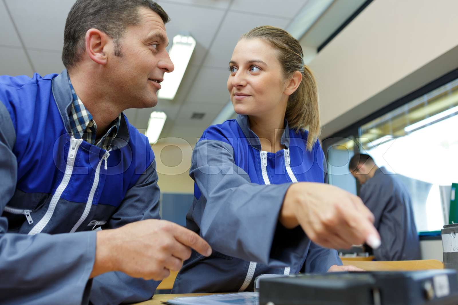 portrait of blue collar workers discussing something | Stock image ...