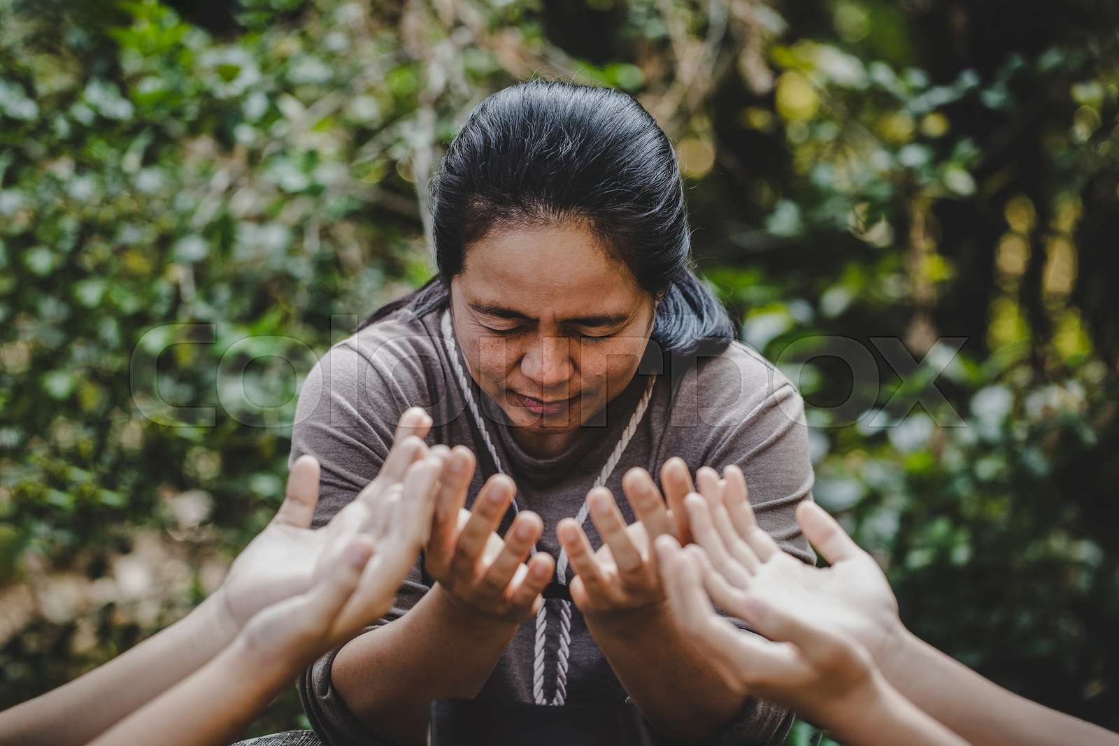 Group of different women praying together | Stock image | Colourbox