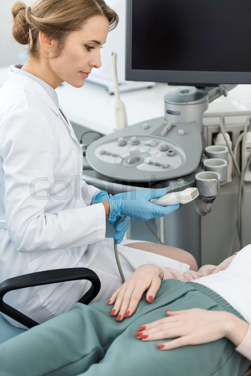 professional doctor making ultrasound scan to patient in clinic | Stock ...