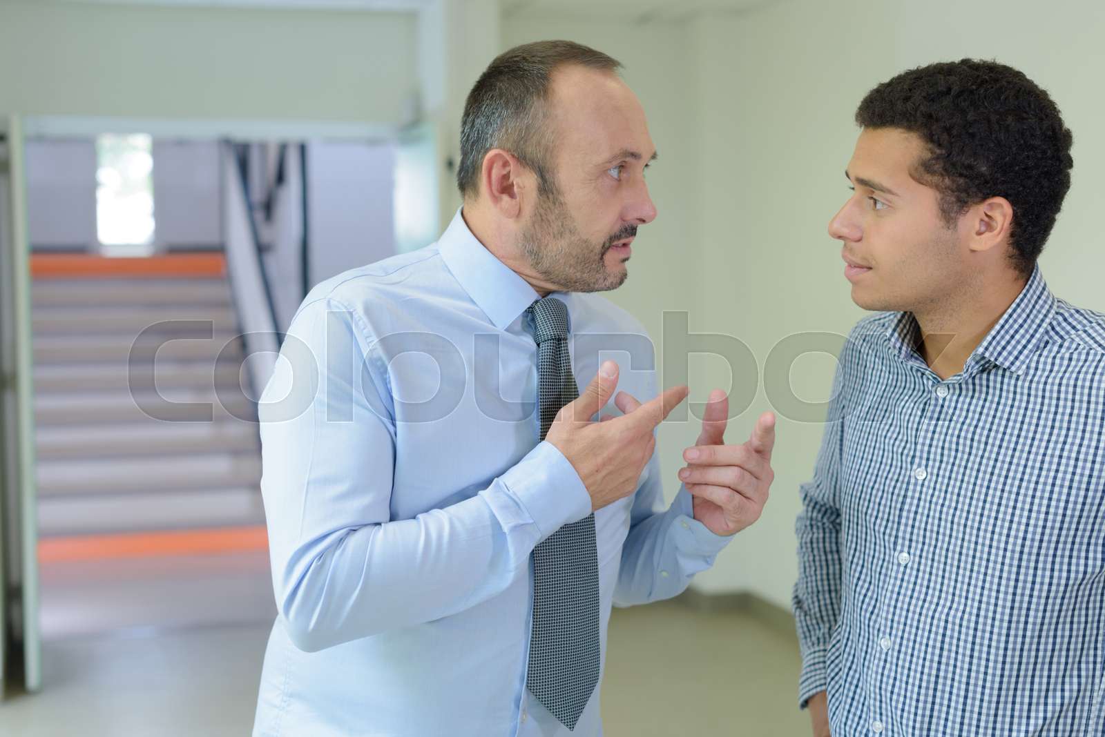 supervisor giving speech to his intern | Stock image | Colourbox