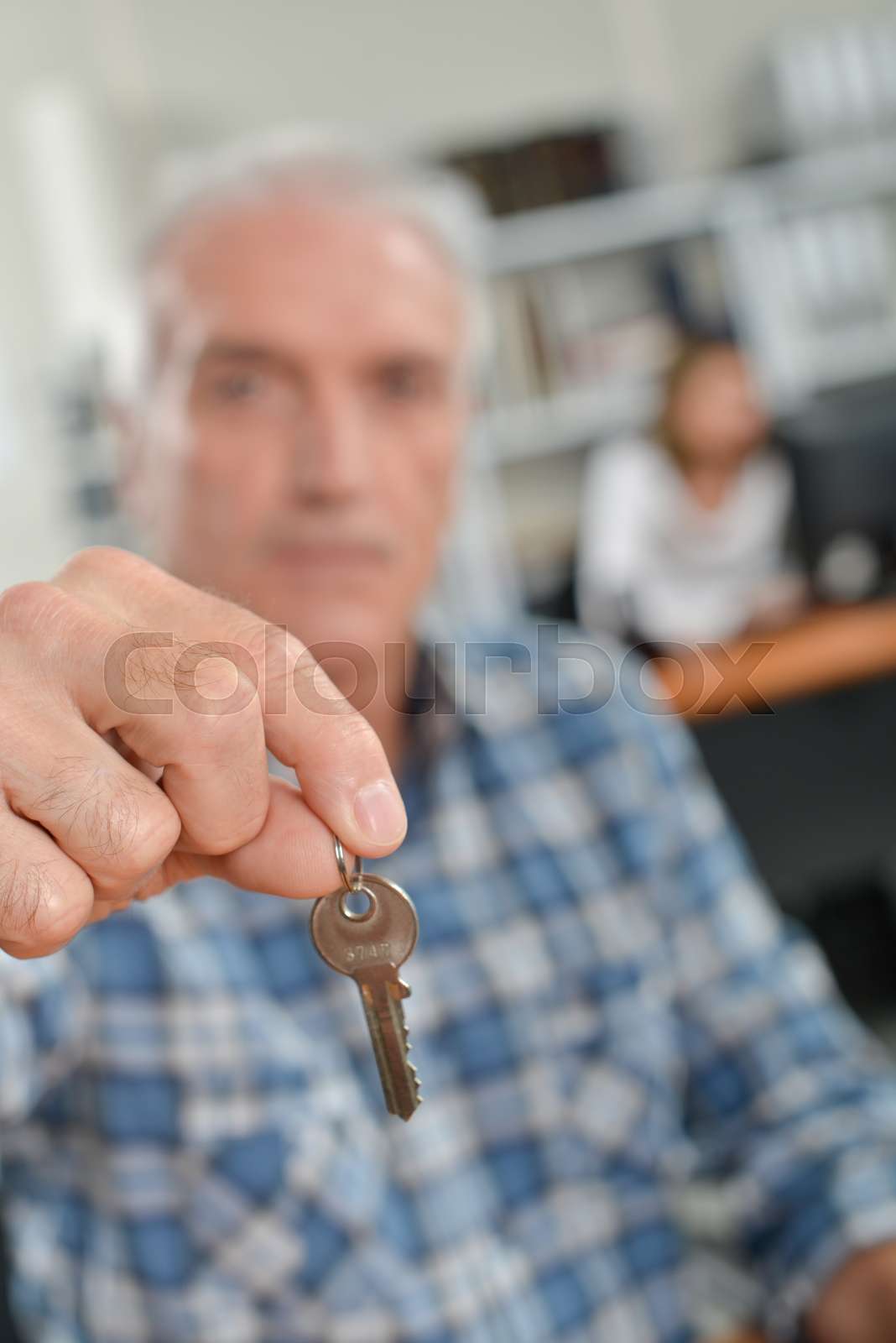 Estate agent handing over keys | Stock image | Colourbox