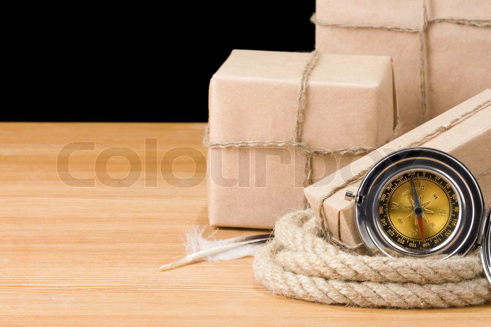parcel wrapped box and rope isolated on black | Stock image | Colourbox