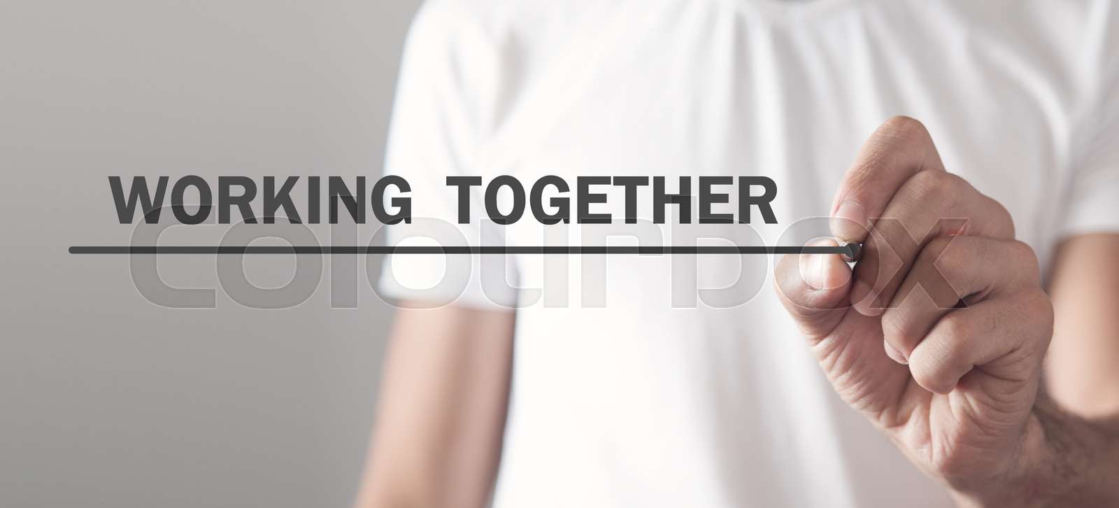 Man writing Working Together text in screen. | Stock image | Colourbox