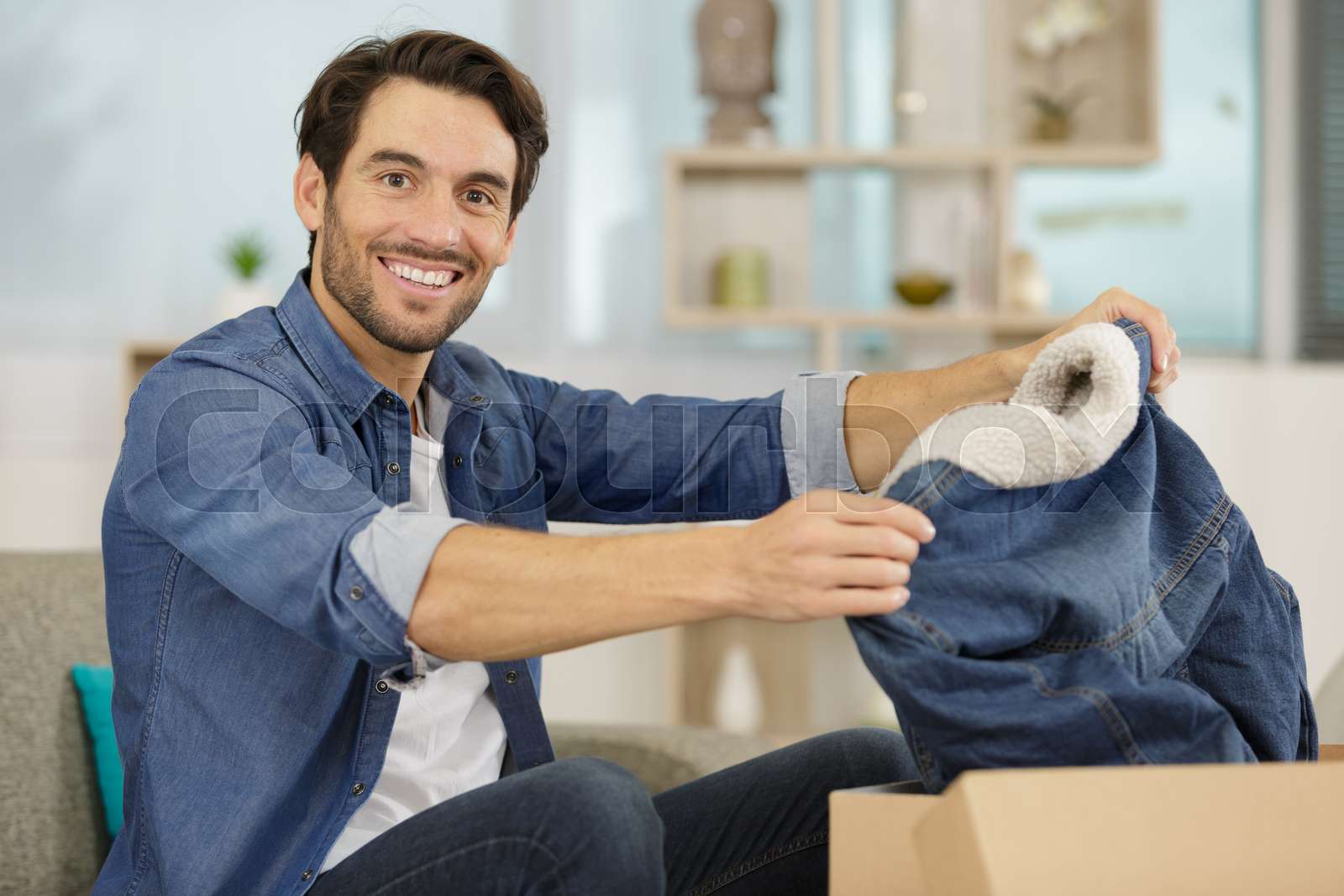 man opening a parcel | Stock image | Colourbox