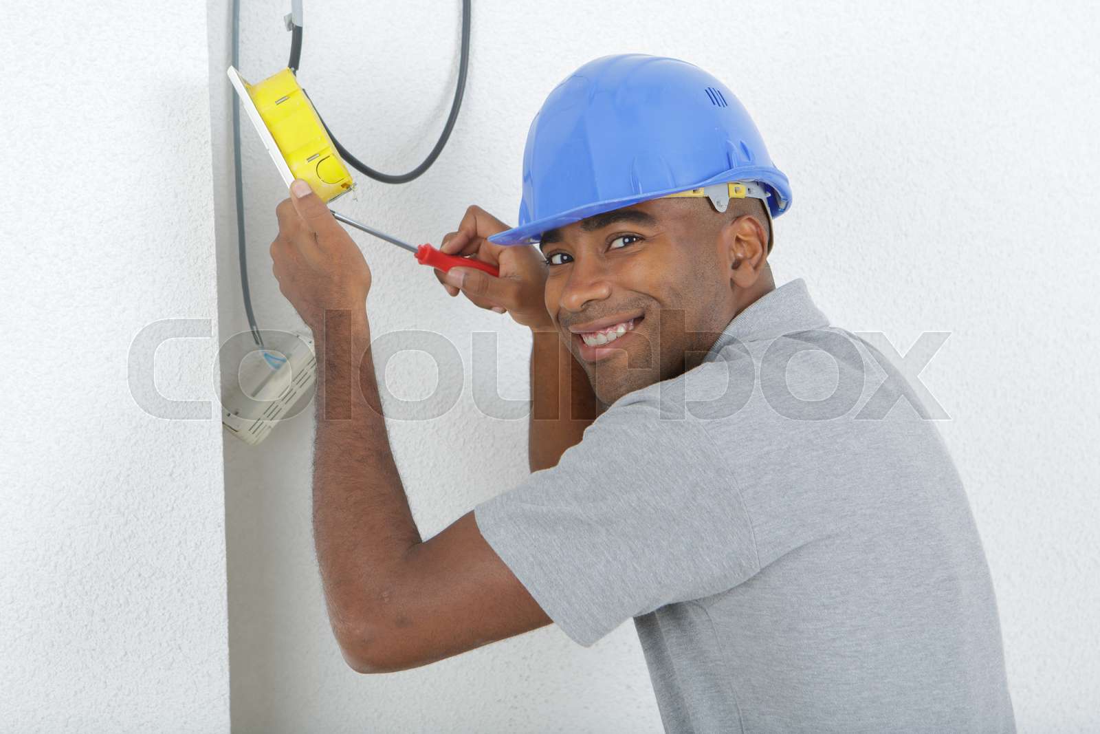 a male electrician is working | Stock image | Colourbox