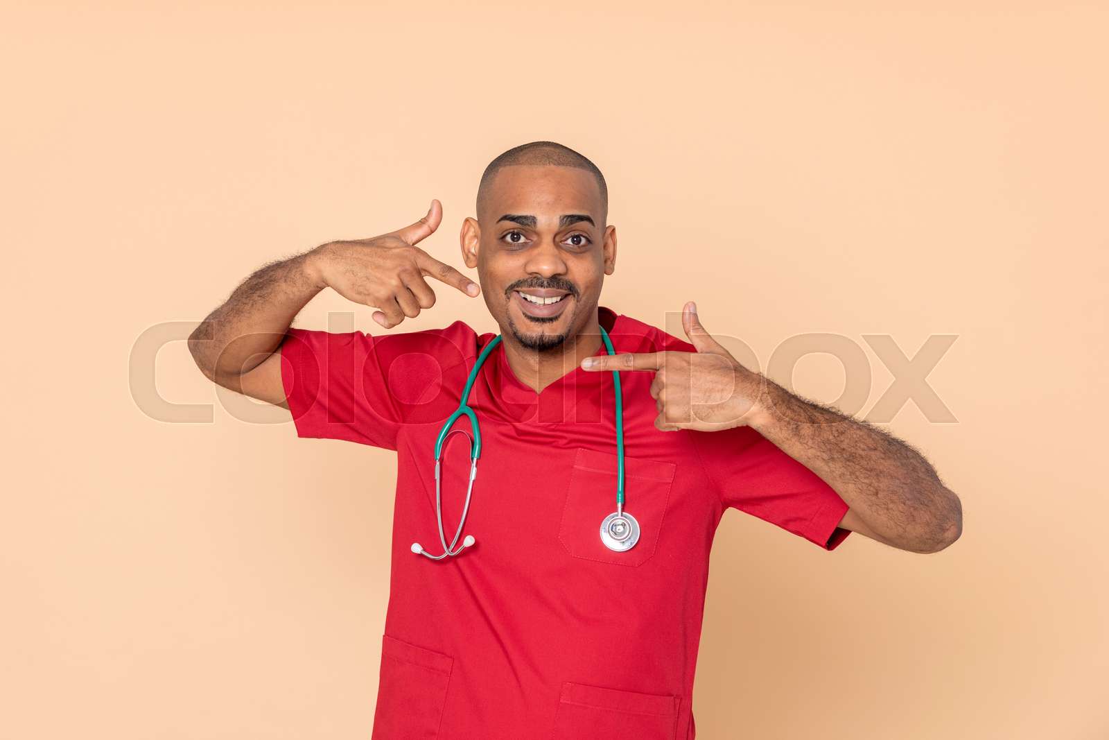 African doctor wearing a red uniform | Stock image | Colourbox