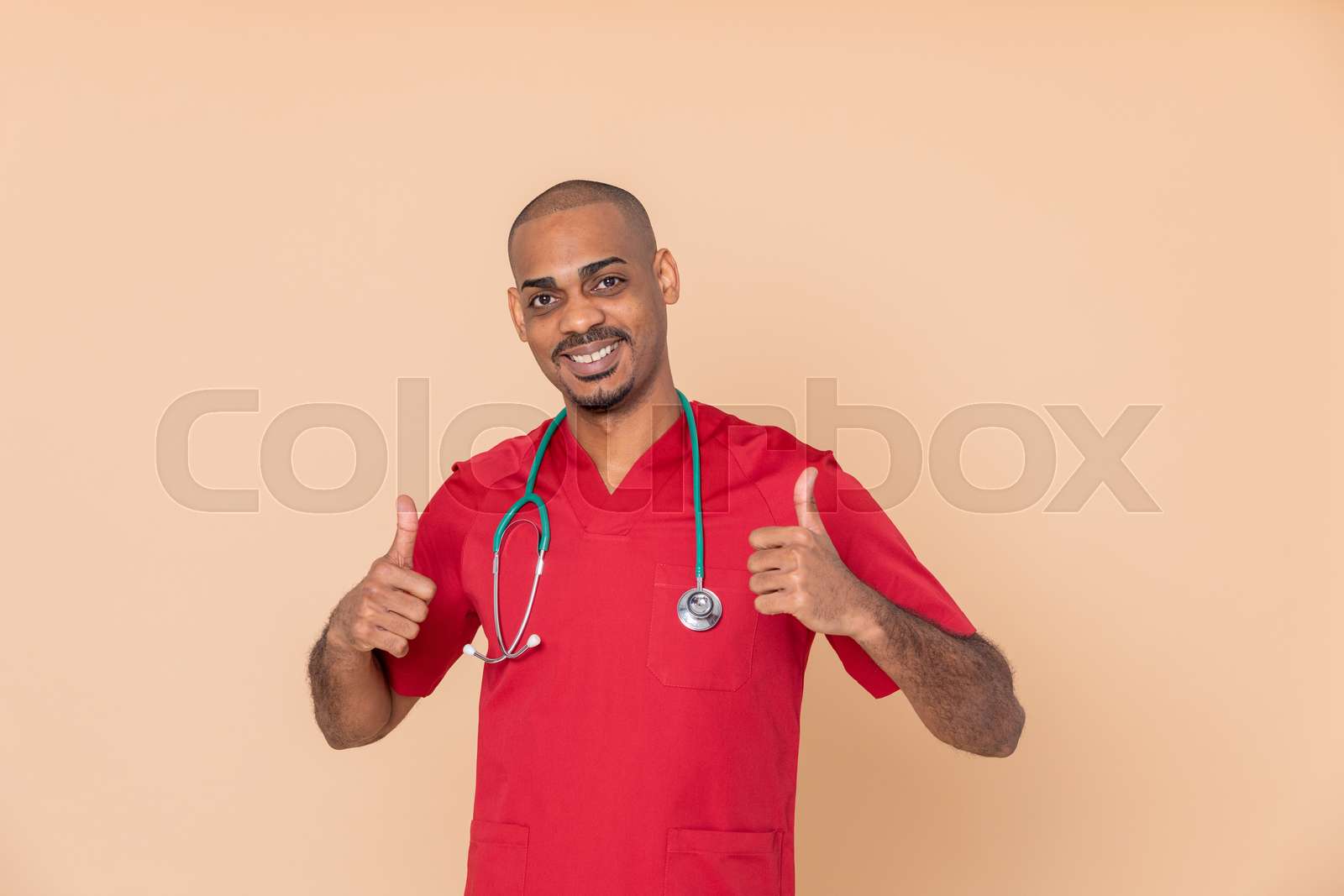 African doctor wearing a red uniform | Stock image | Colourbox