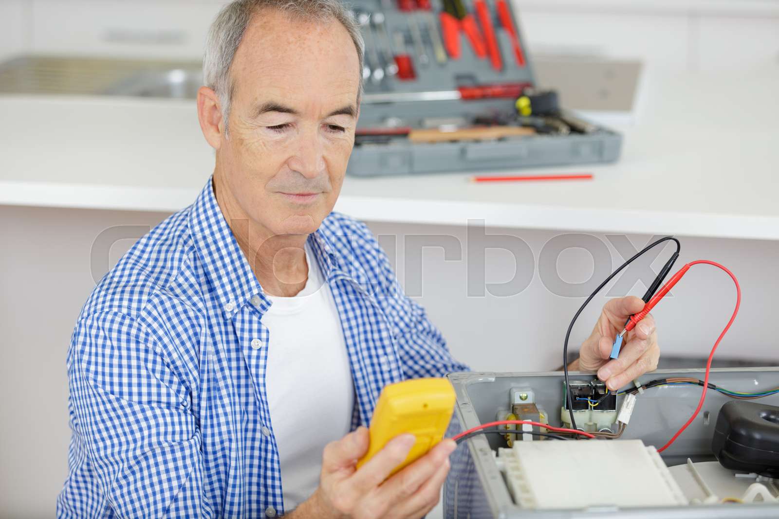 a mature electrician at work | Stock image | Colourbox