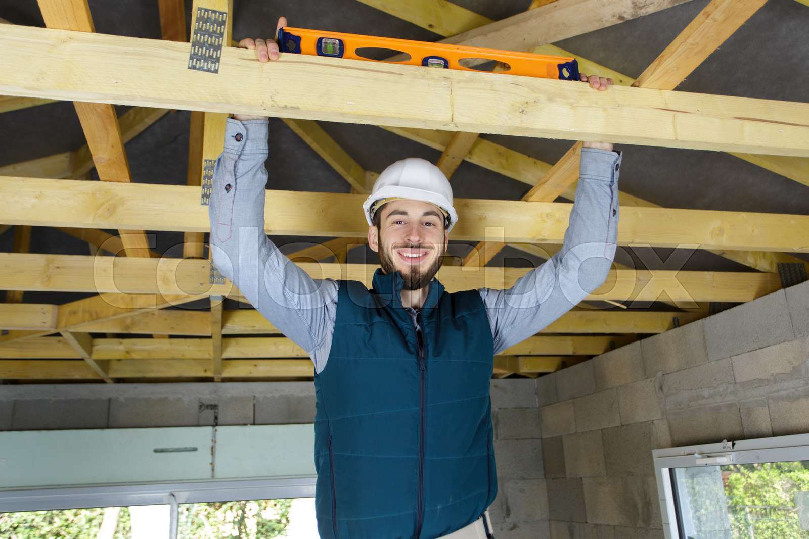 happy male construction worker adjusting ceiling | Stock image | Colourbox