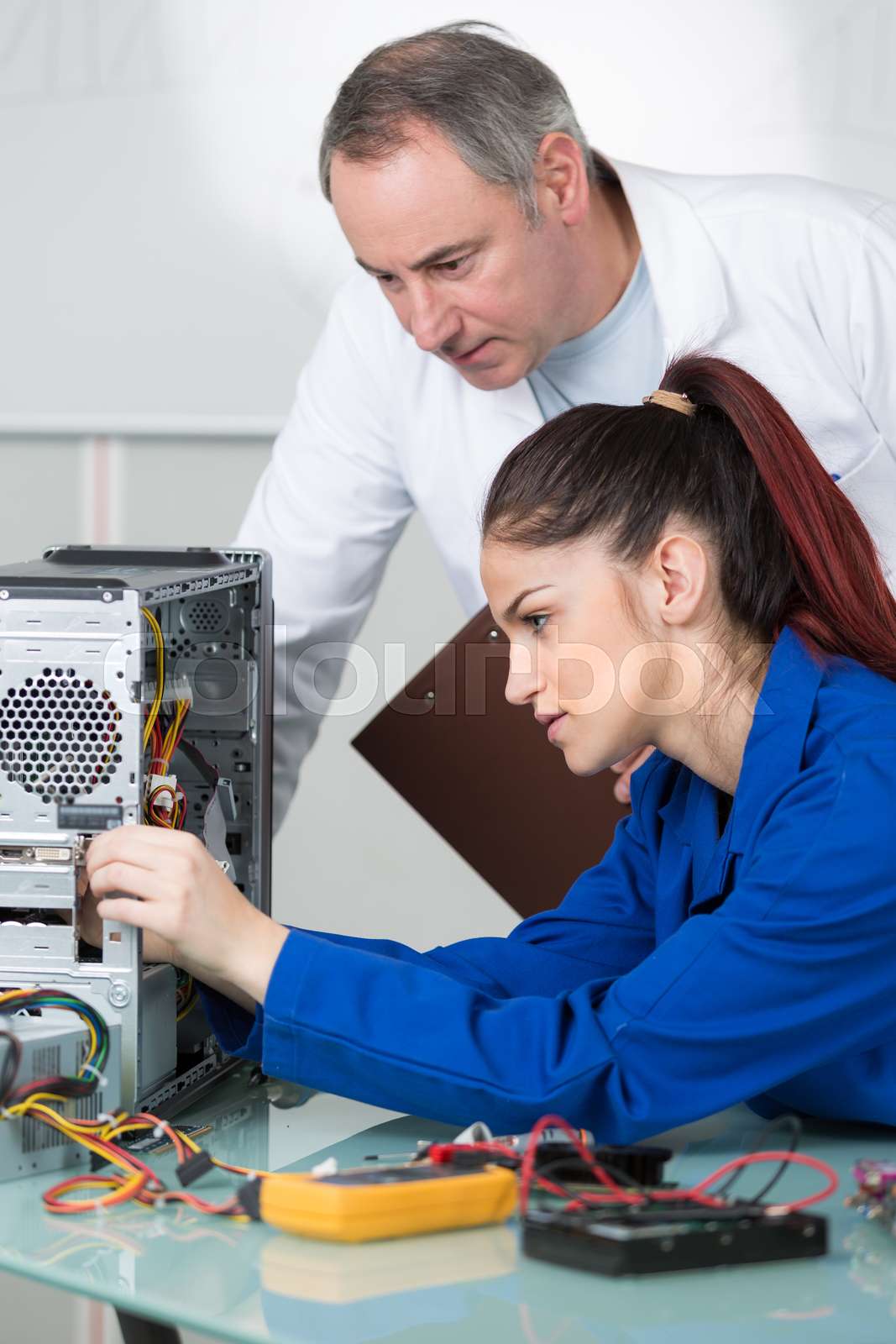teacher showing student on whiteboard how to fix a computer | Stock ...