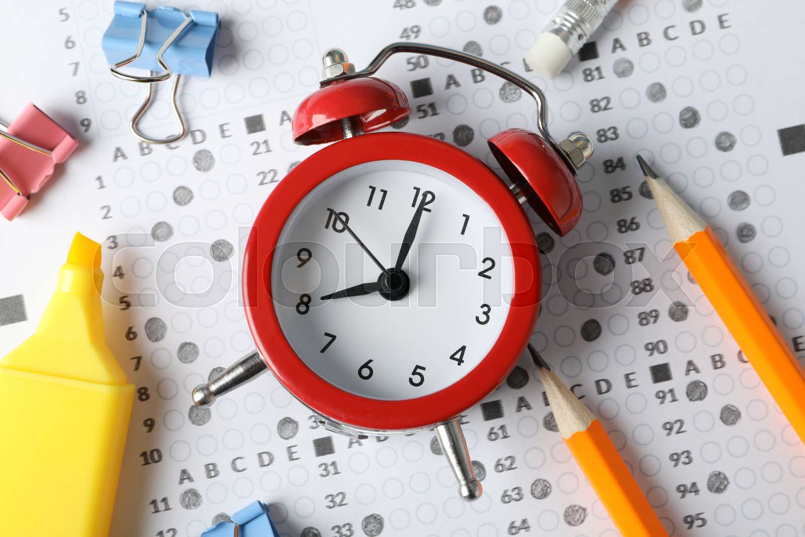 Test score sheet, alarm clock and stationery, close up | Stock image ...