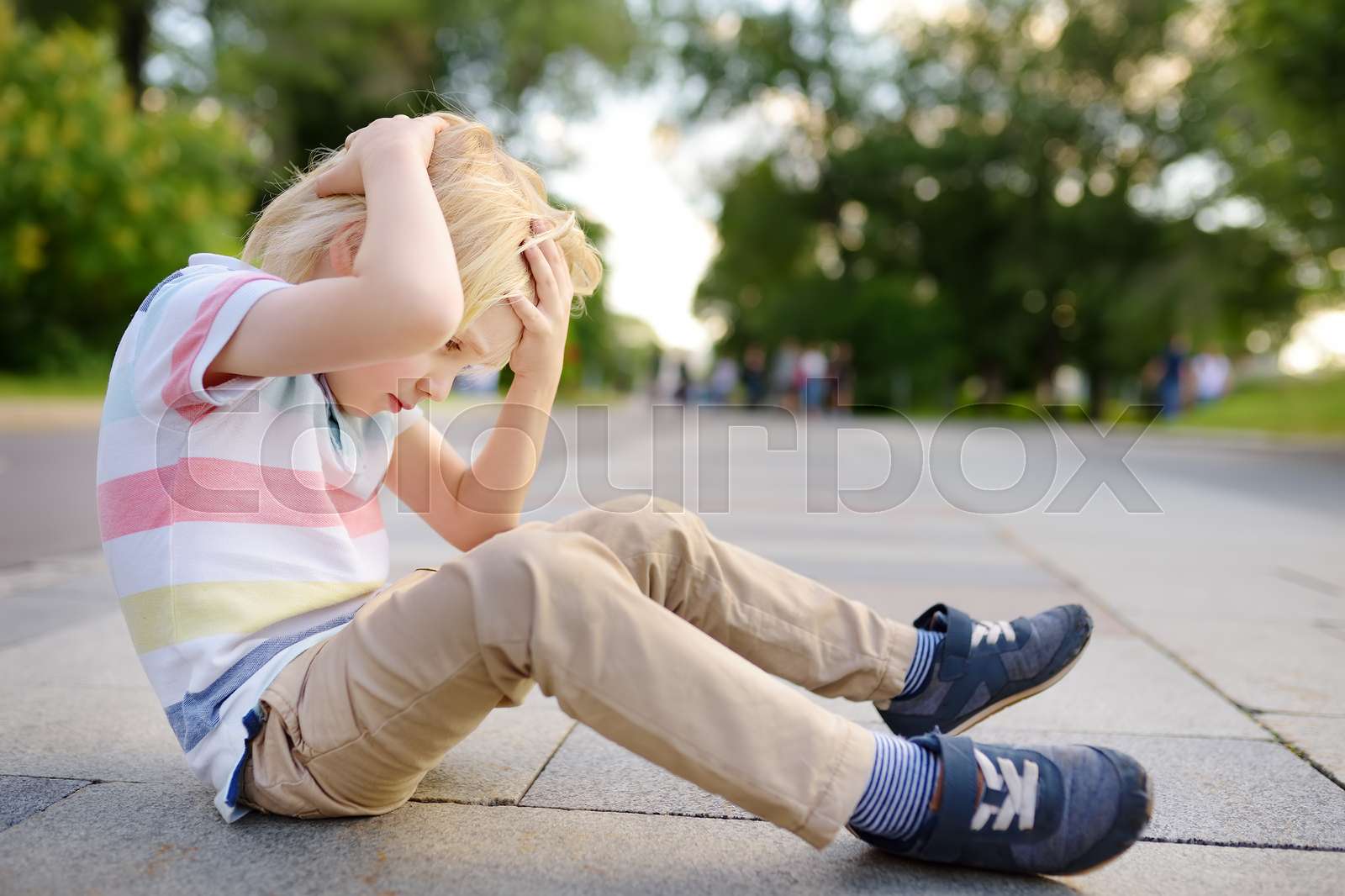 Little boy fell in the street, hit his head. Injury. | Stock image ...